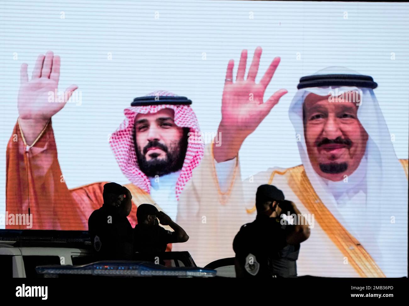 FILE - Saudi special forces salute in front of a screen displaying ...