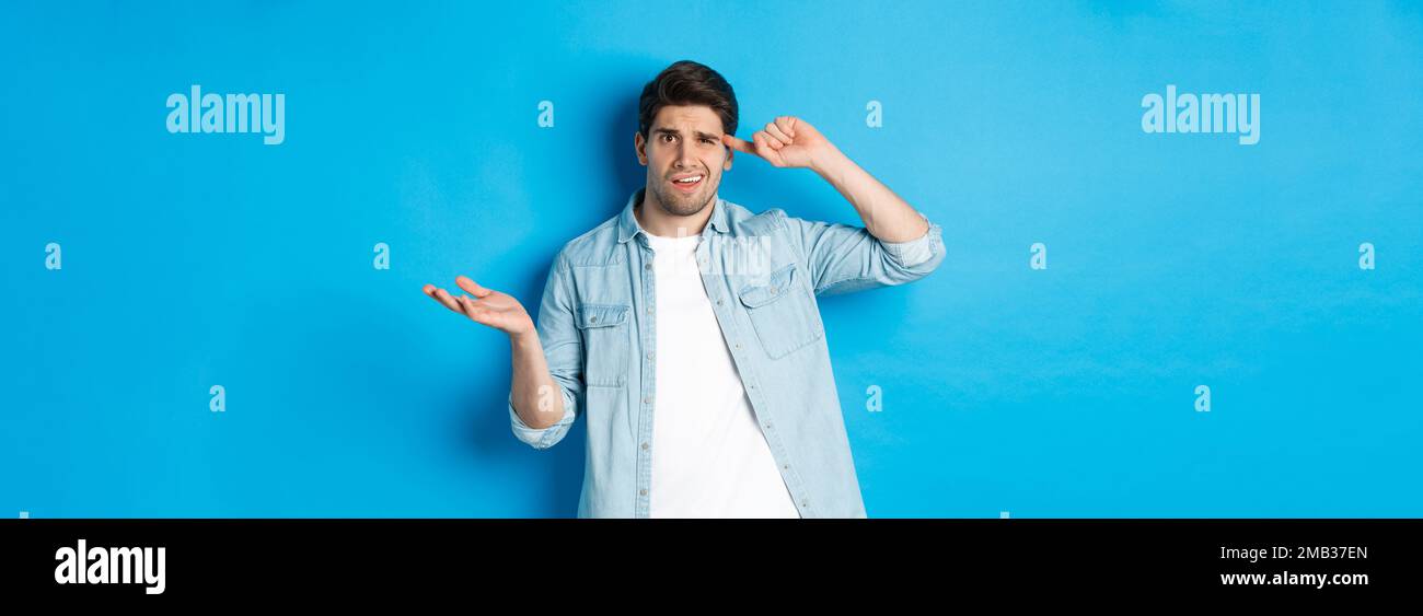 Confused man scolding person for being stupid, pointing finger at head ...