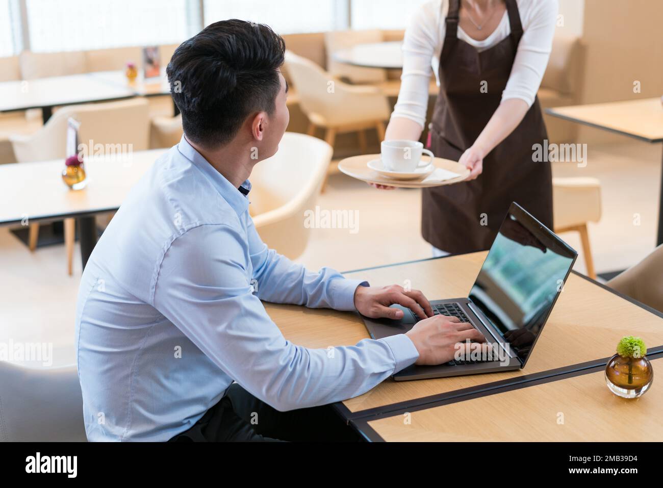 The waiter brought the customer coffee Stock Photo - Alamy
