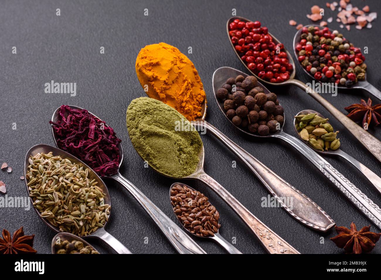Composition consisting of variations of spices in white bowls and metal ...