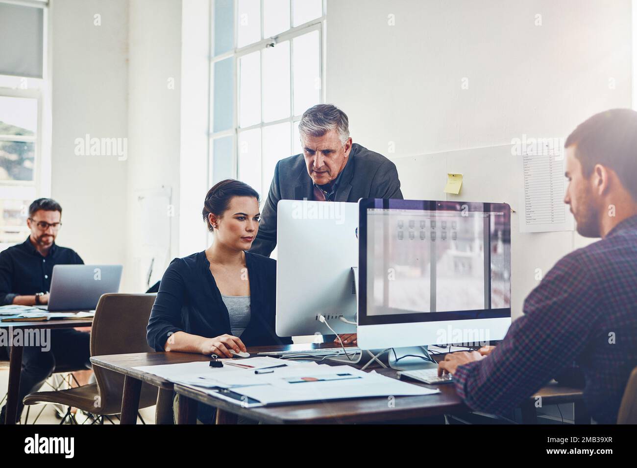 Coaching, training and business people with computer in office ...