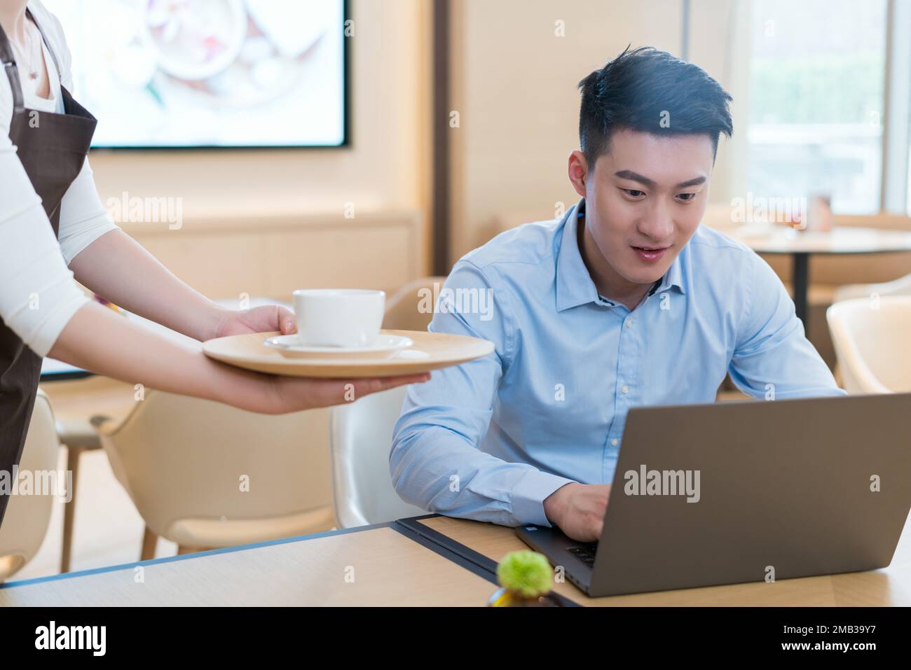 The waiter brought the customer coffee Stock Photo - Alamy