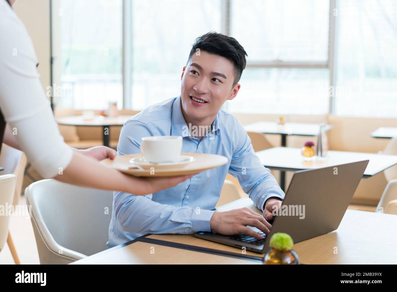 The waiter brought the customer coffee Stock Photo - Alamy