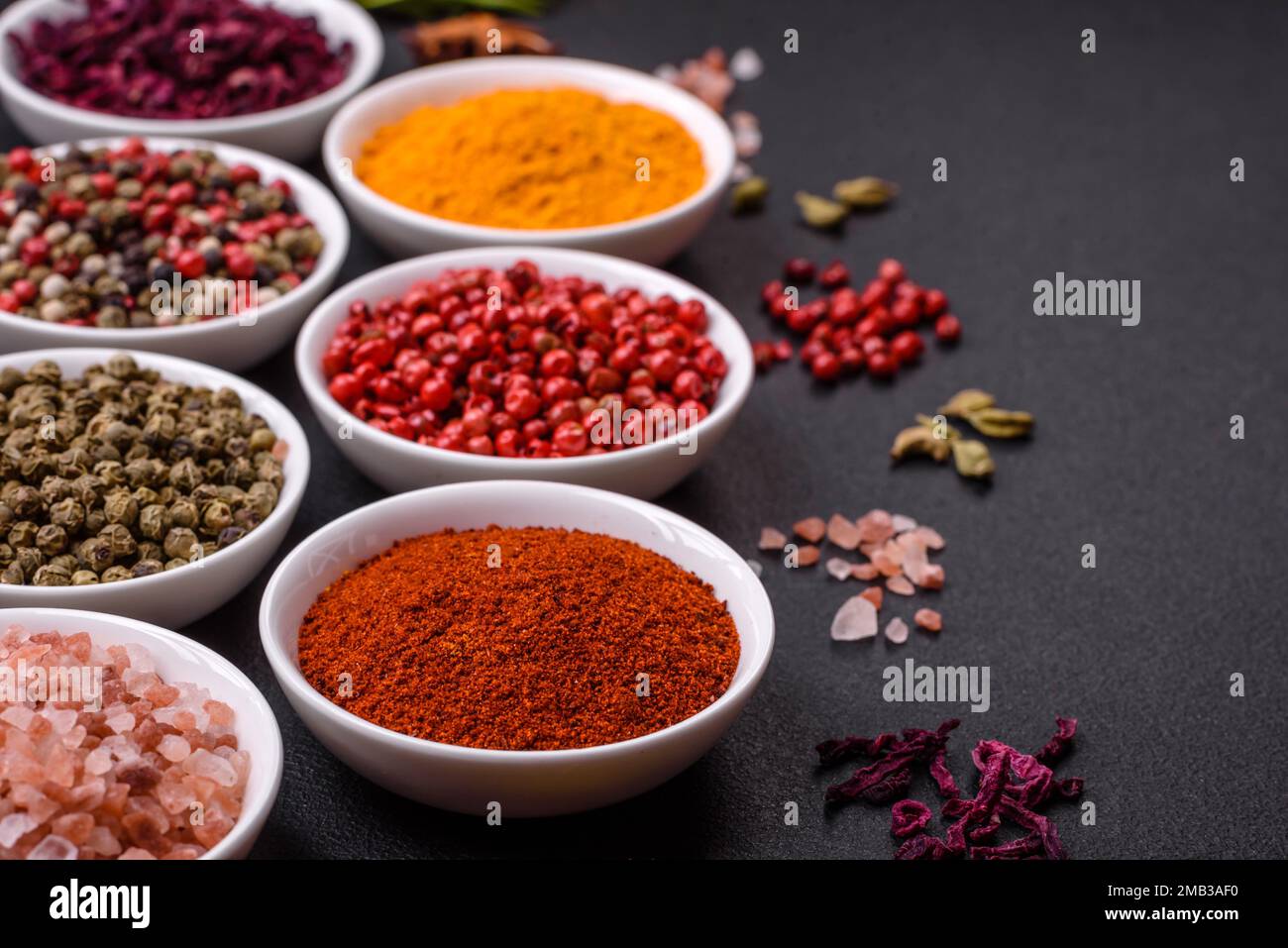 Composition consisting of variations of spices in white bowls and metal ...