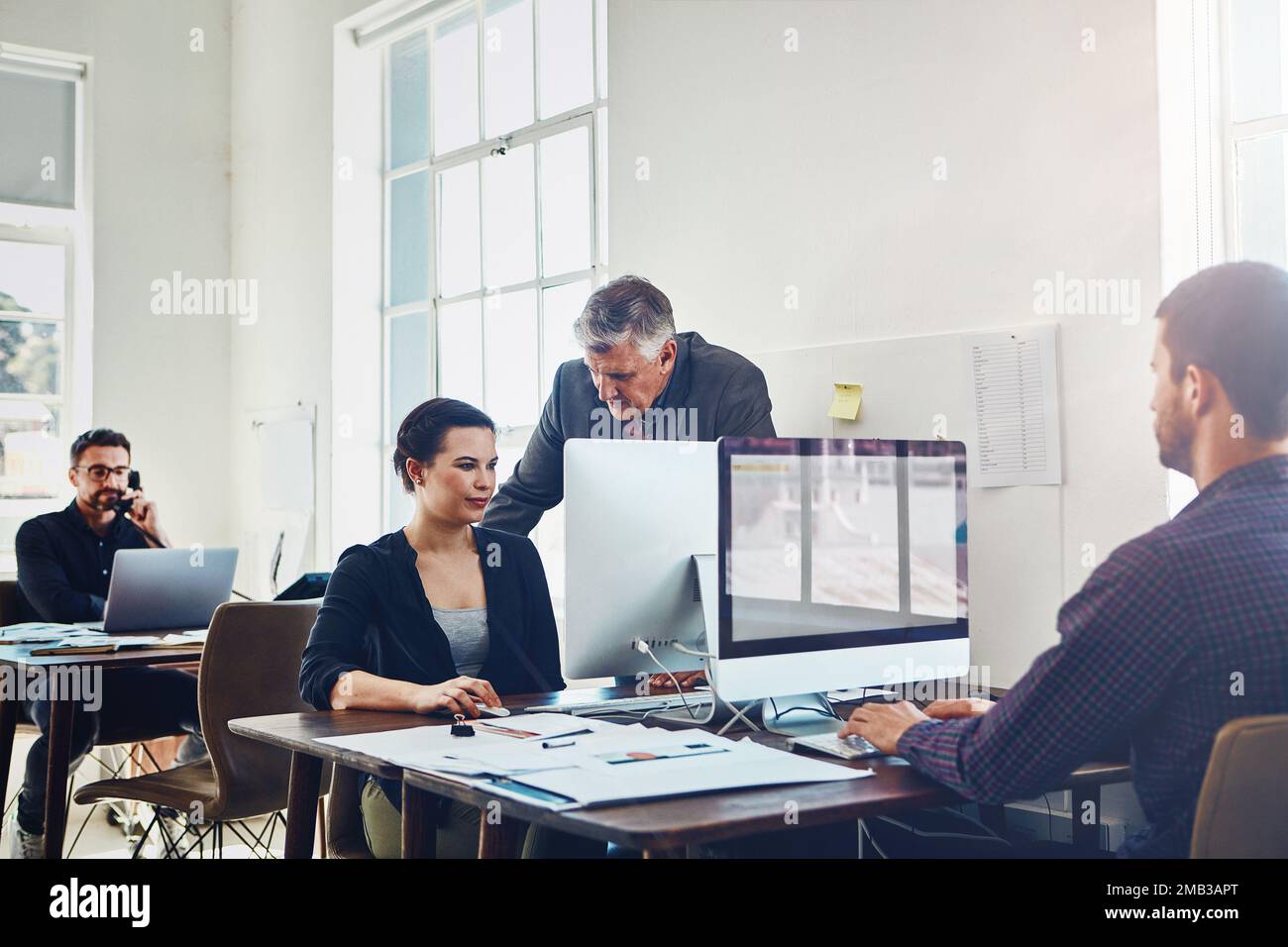 Office, coaching and business people training with computer. Mentor, teamwork and collaboration ...