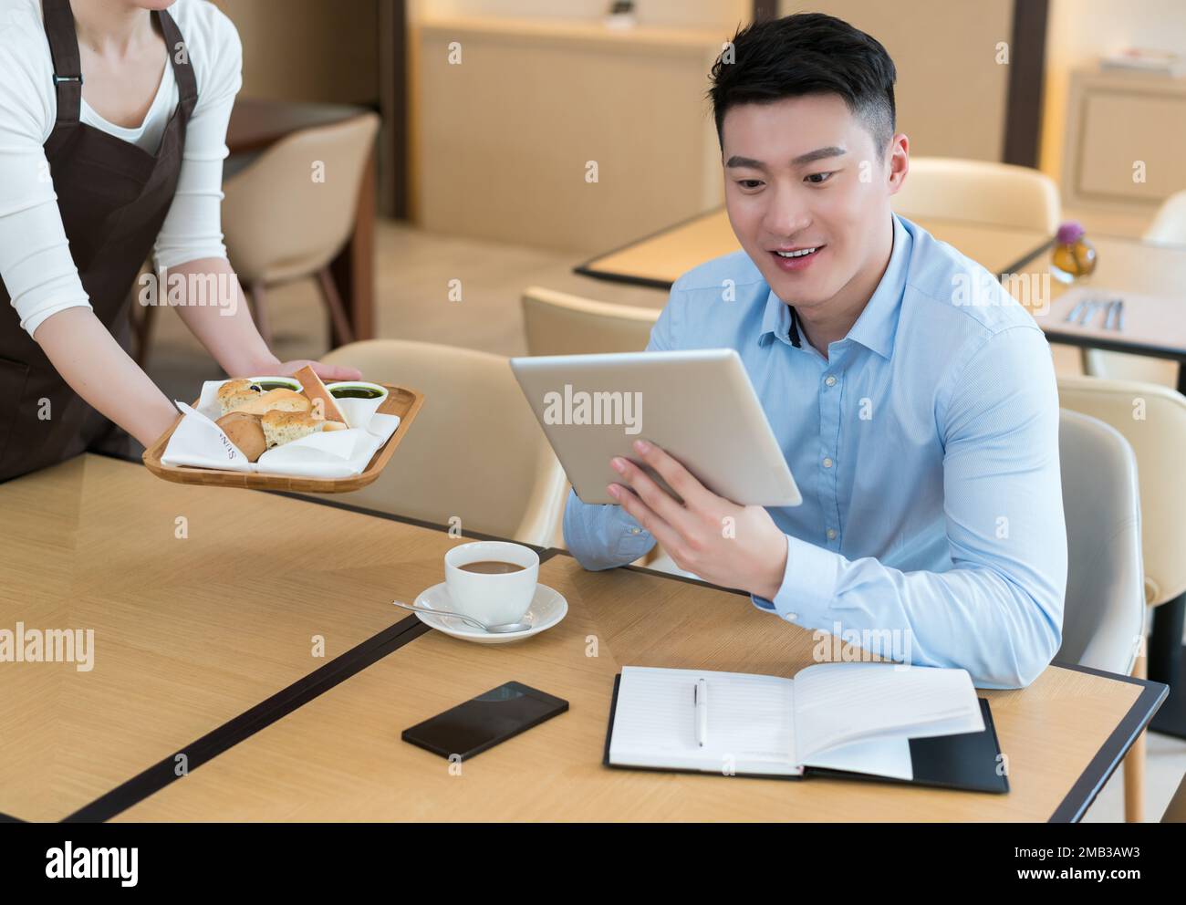 The waiter brought the customer in the afternoon tea Stock Photo - Alamy