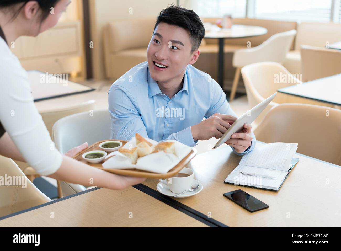 The waiter brought the customer in the afternoon tea Stock Photo - Alamy