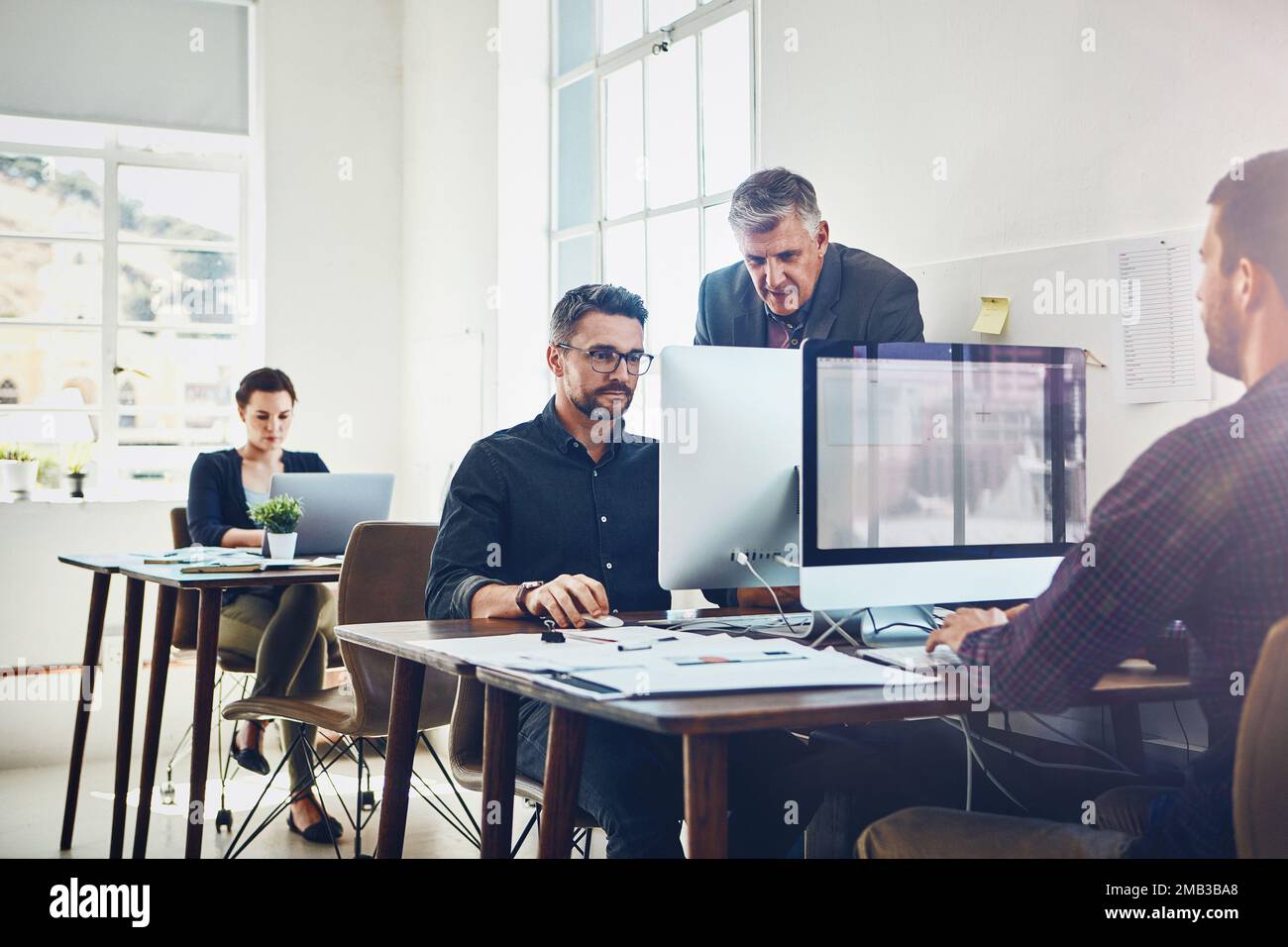 Training, coaching and business people with computer in office ...