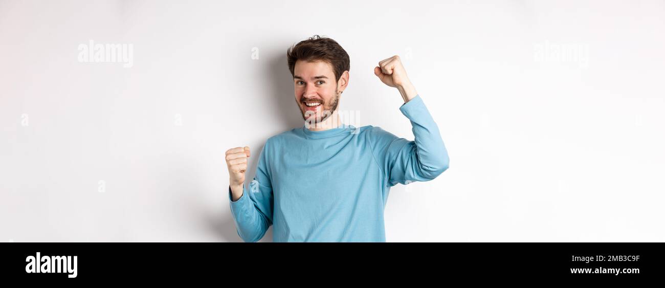 Happy bearded man celebrating victory, raising hands up and triumphing ...