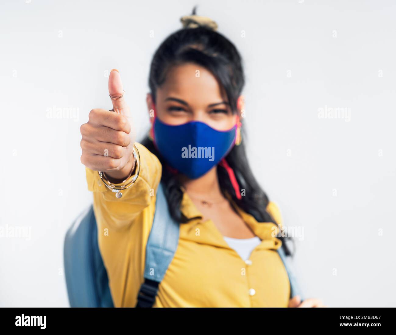 Im ready to go. Studio shot of a young woman showing thumbs up while ...