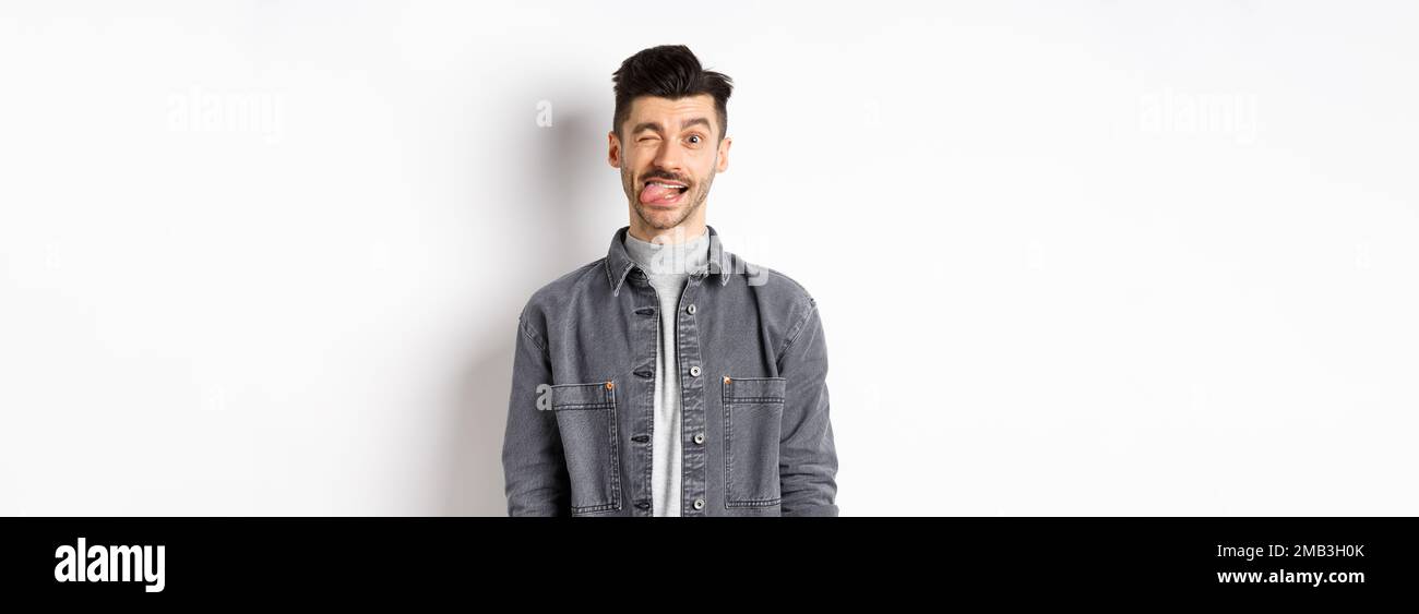 Funny guy with moustache showing tongue and winking, making you laugh ...