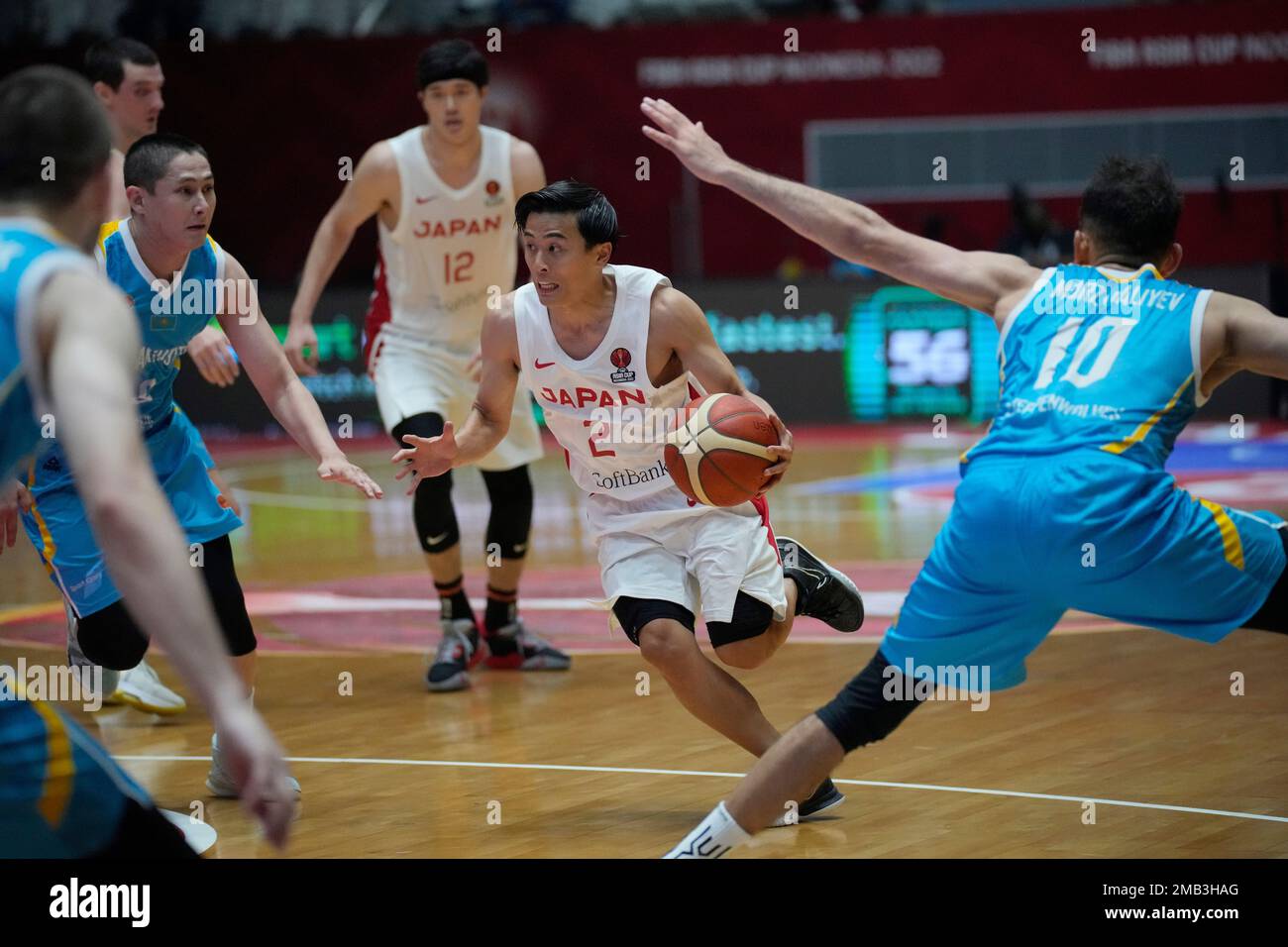 Japan's Yuki Togashi, center, drives past Kazakhstan's Rustam ...