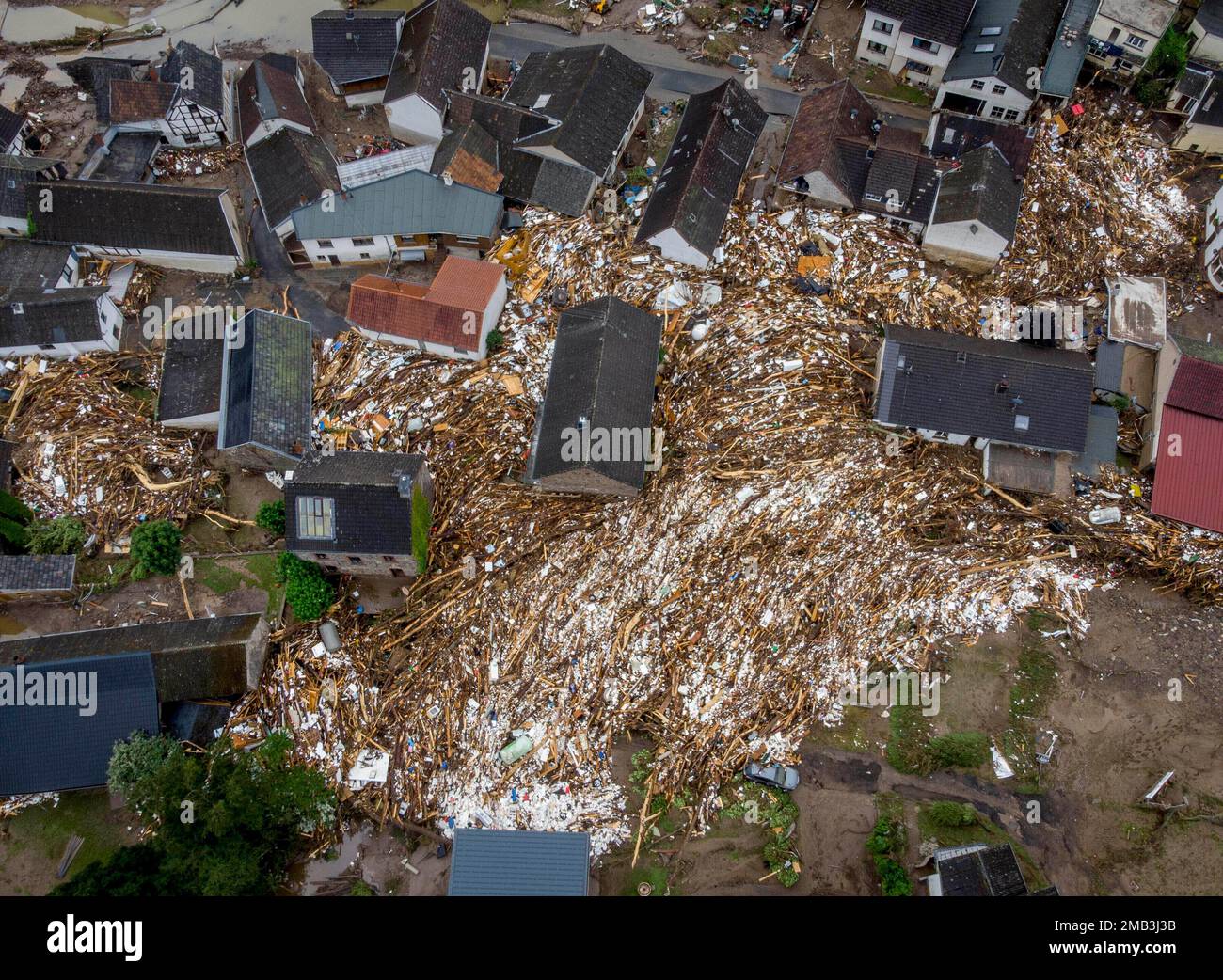 FILE - Debris from a flood lies around destroyed houses close to the ...
