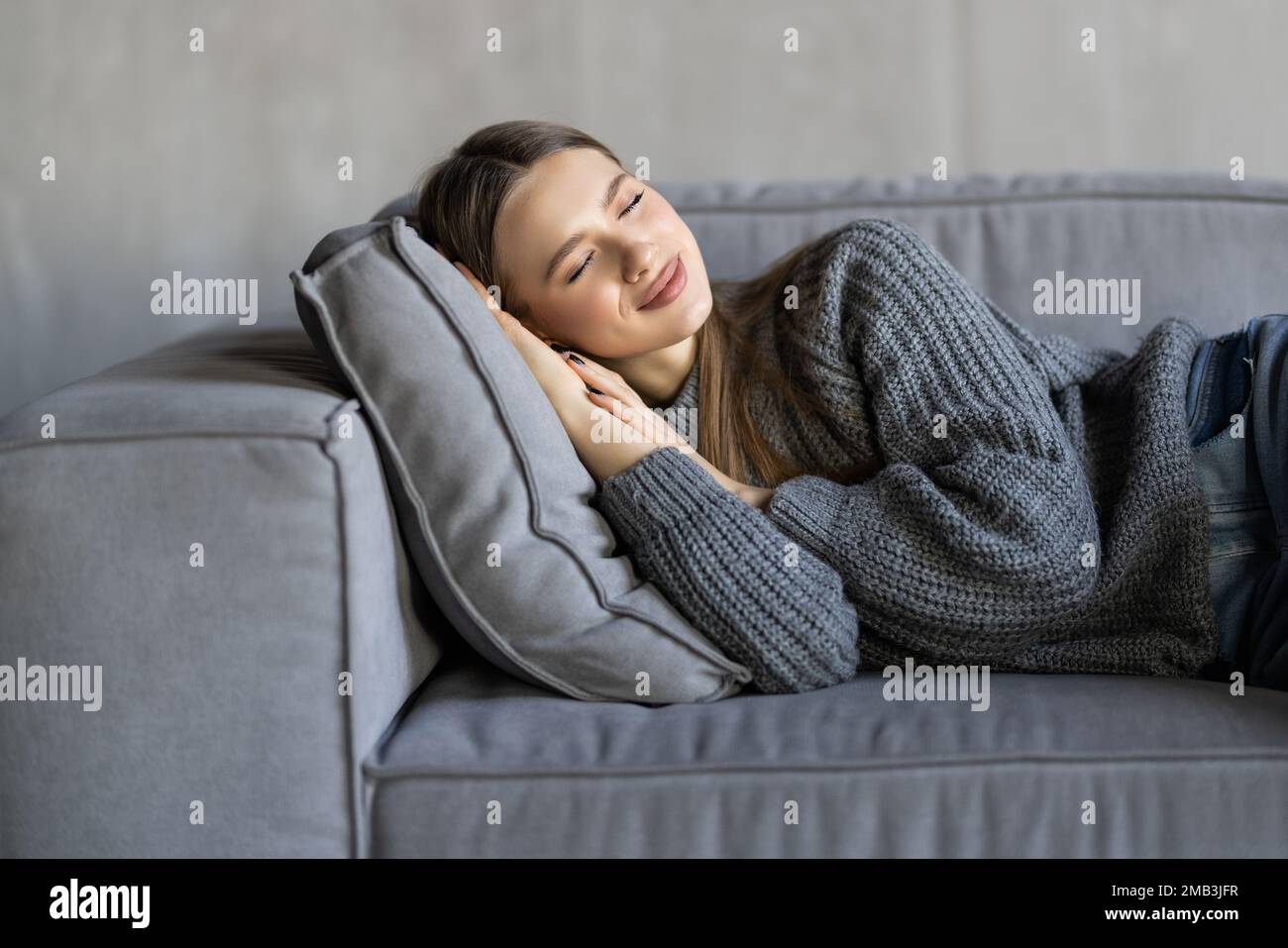 tired millennial female fall asleep on couch at home, take nap or ...
