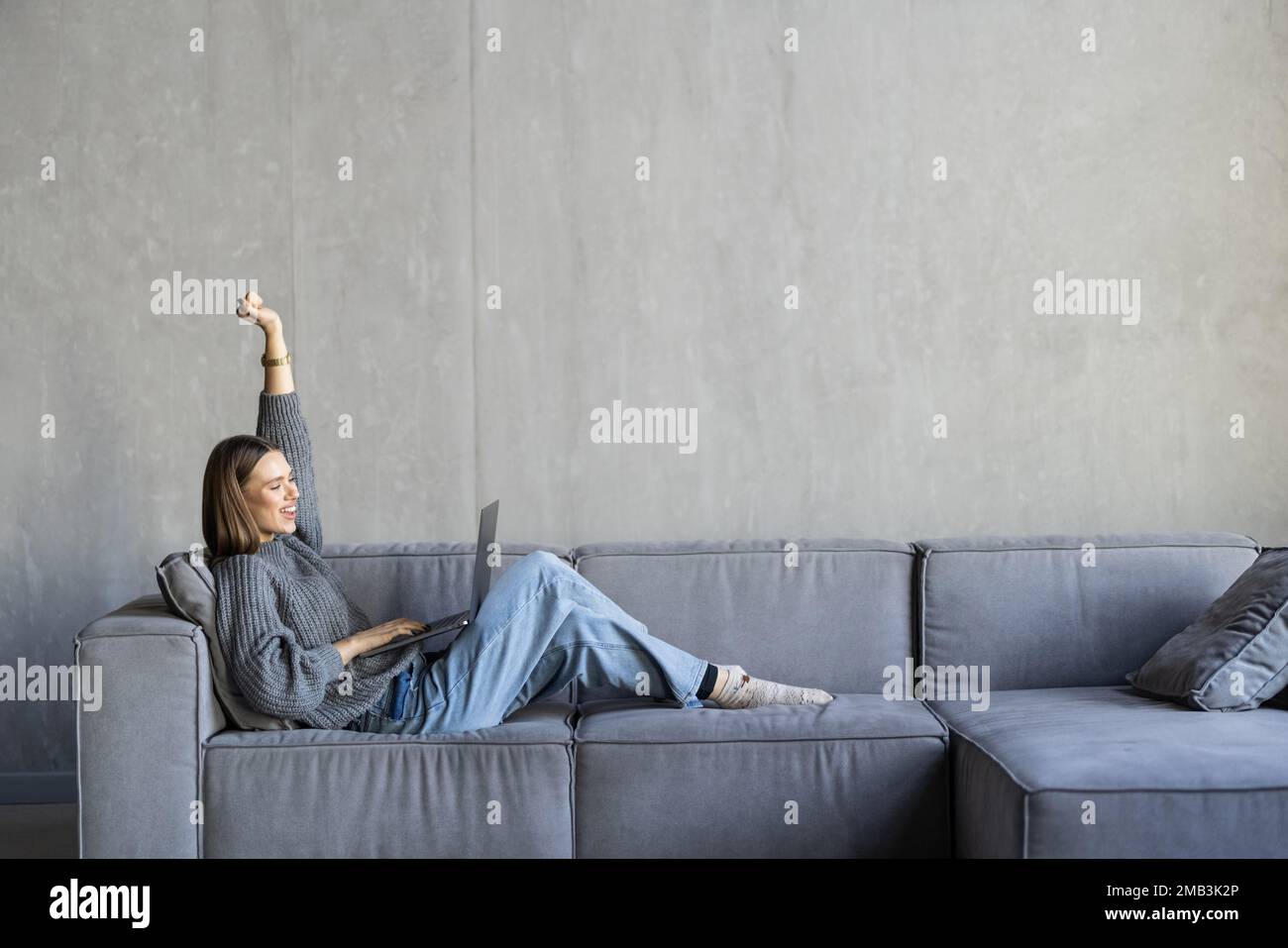 Calm pretty millennial woman lying on cozy sofa relaxing on weekend ...