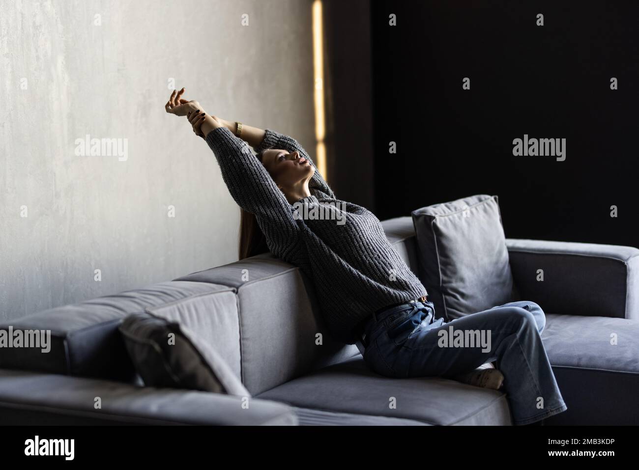 Calm pretty millennial woman lying on cozy sofa relaxing on weekend ...