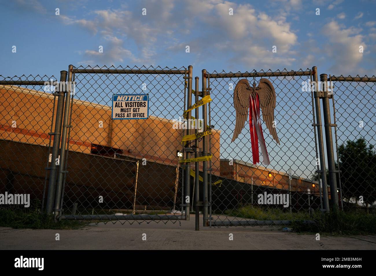 Angel wings and a cross hang on a gate that remains locked at Robb ...