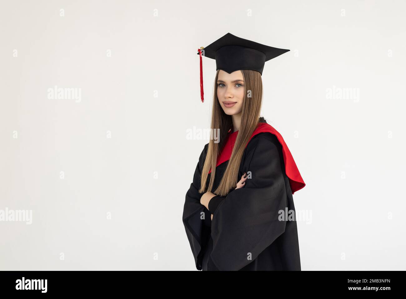 Graduate girl with master degree in black graduation robe and cap on ...