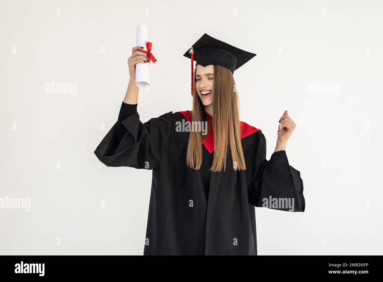 Happy graduate student woman in mortarboard and bachelor gown with ...