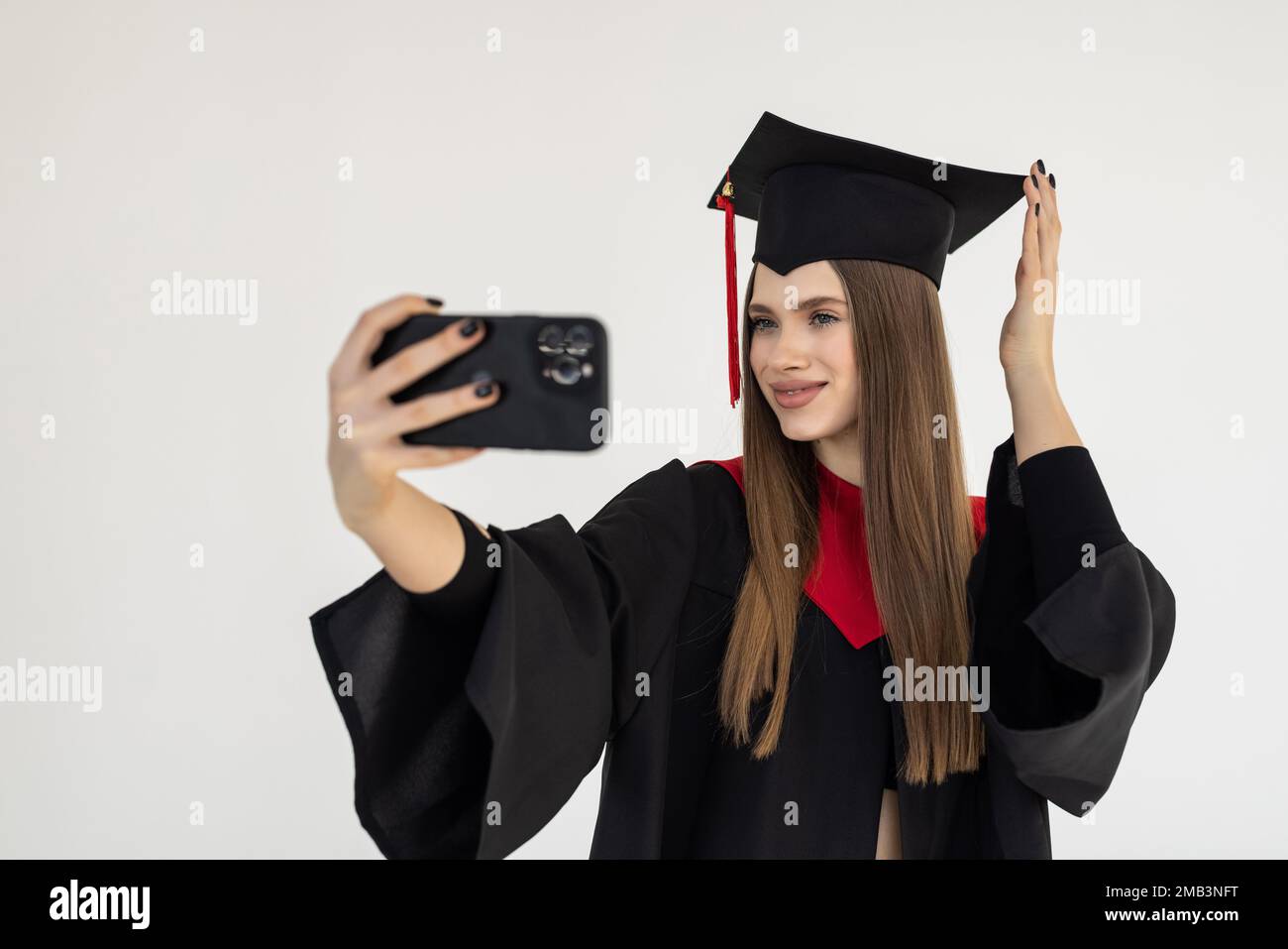 Female graduate taking selfie with diploma on white background Stock ...
