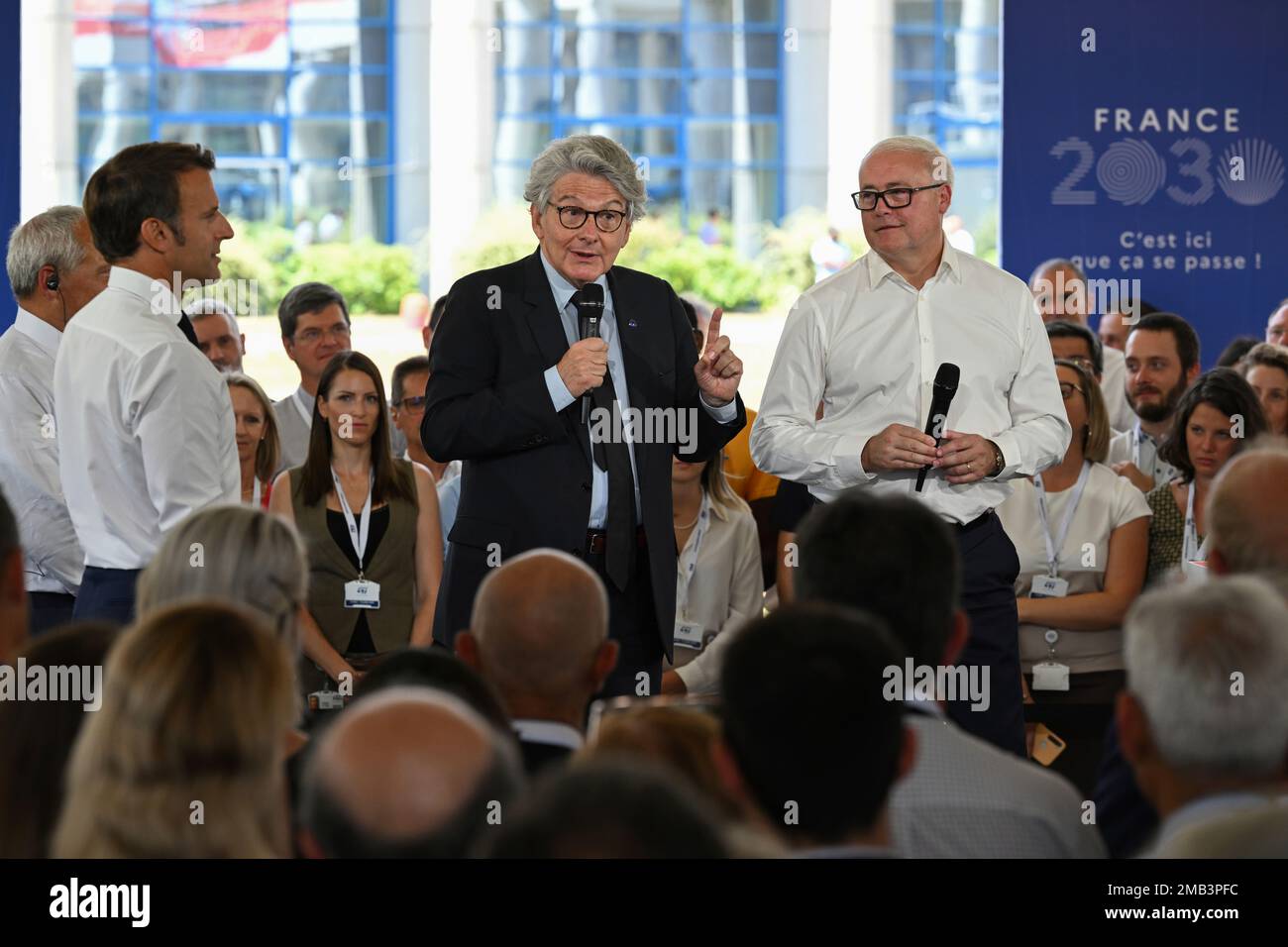 France's President Emmanuel Macron, left flanked by STM chairman Jean ...