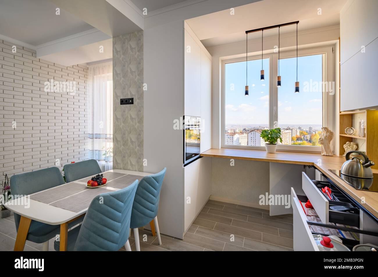 A modern white kitchen with drawers extended Stock Photo - Alamy