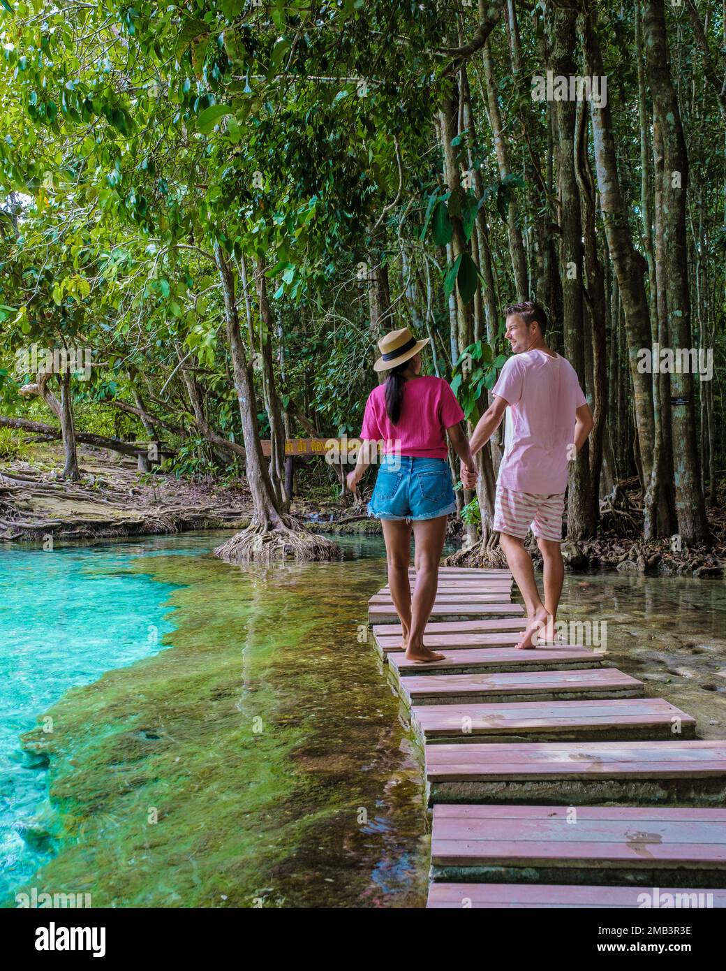 A couple visits the Emerald pool and Blue pool in Krabi Thailand ...
