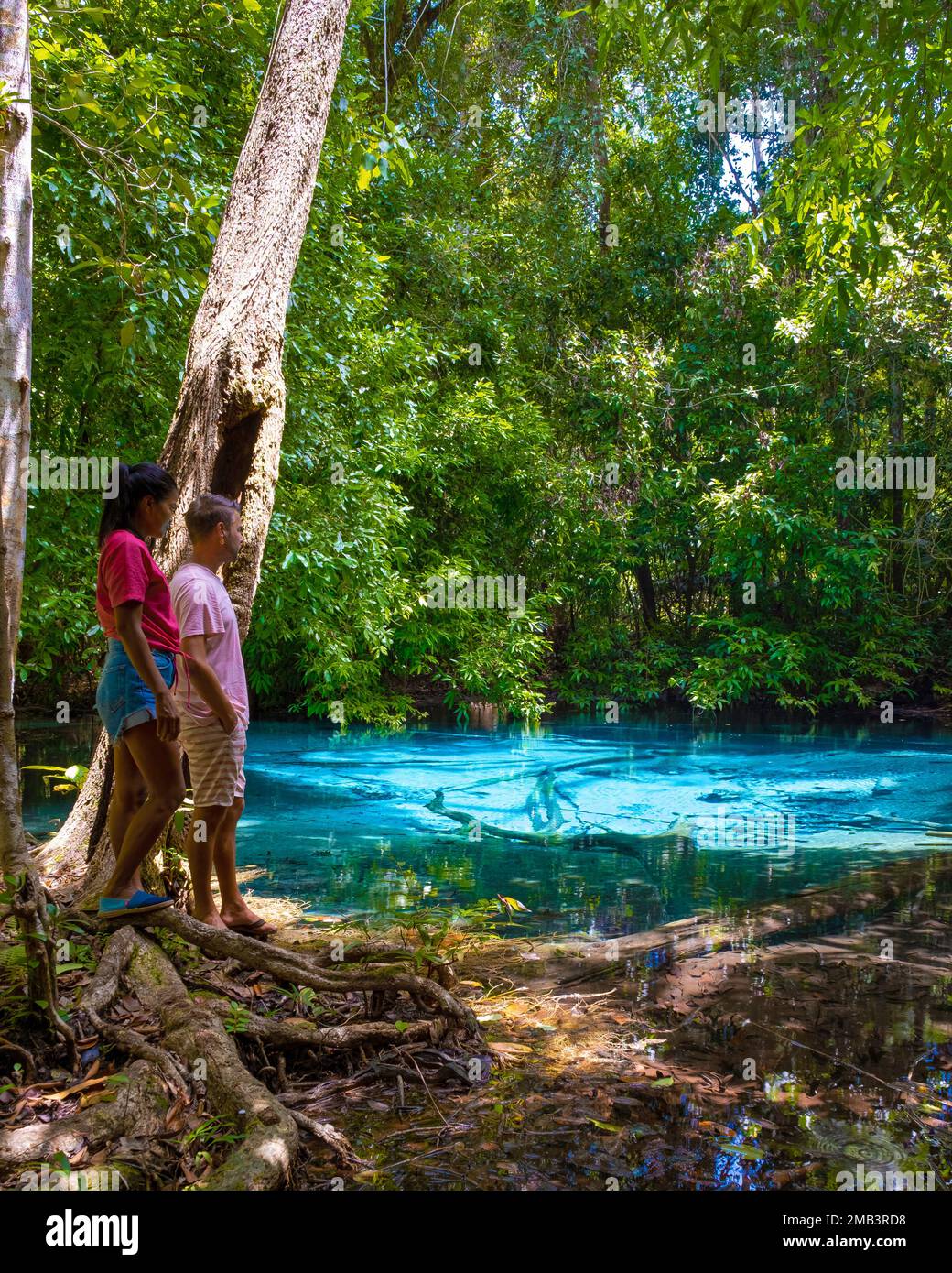 A couple visits the Emerald pool and Blue pool in Krabi Thailand ...