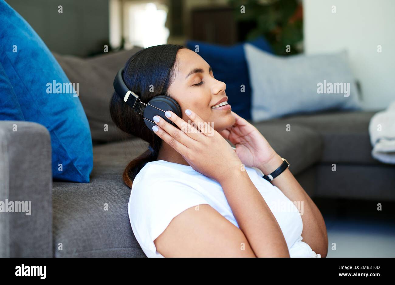 Talk about surround sound. an attractive young woman sitting alone in ...