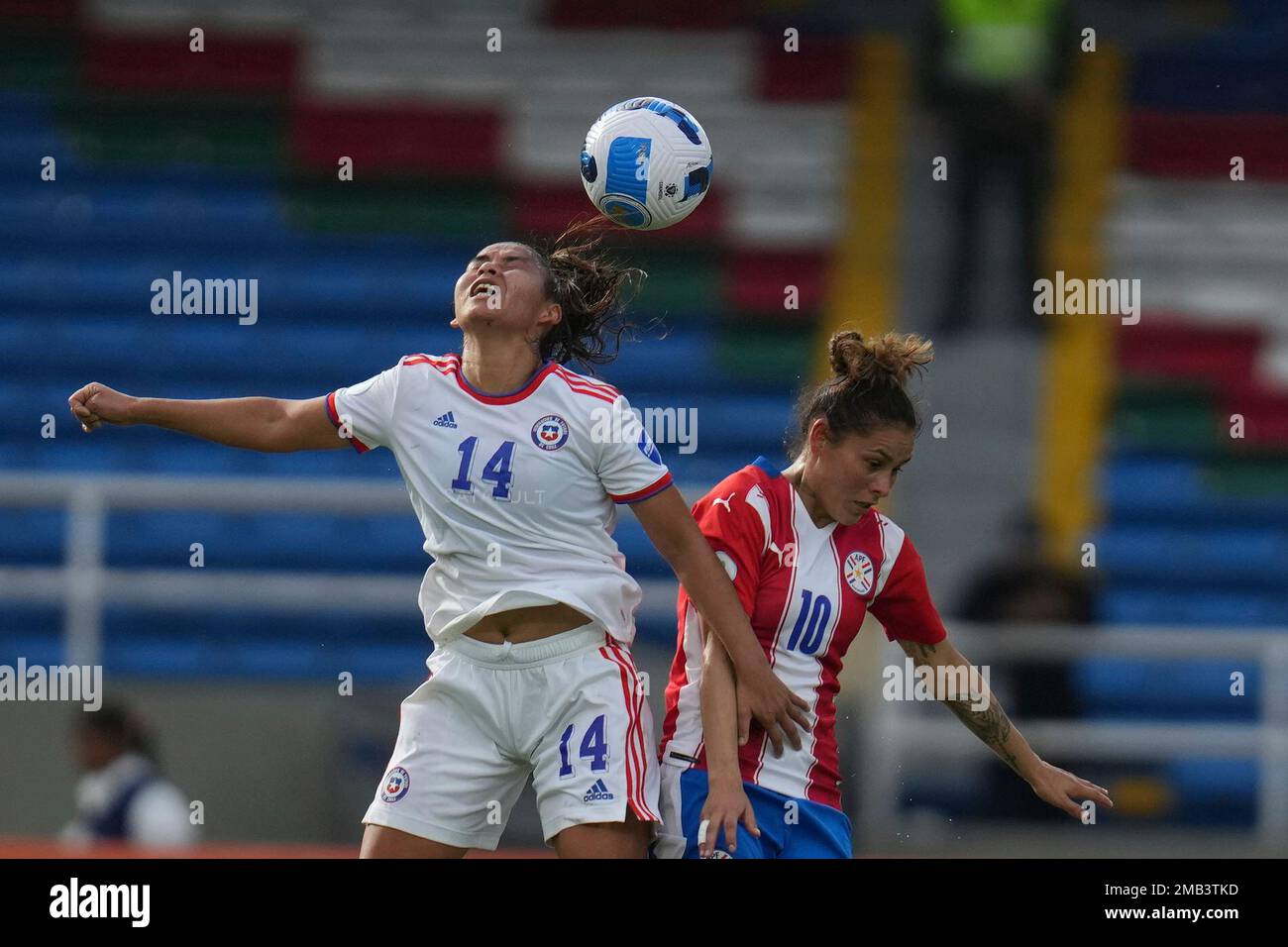 Chile's Daniela Pardo, and Paraguay's Jessica Martinez go for a header ...