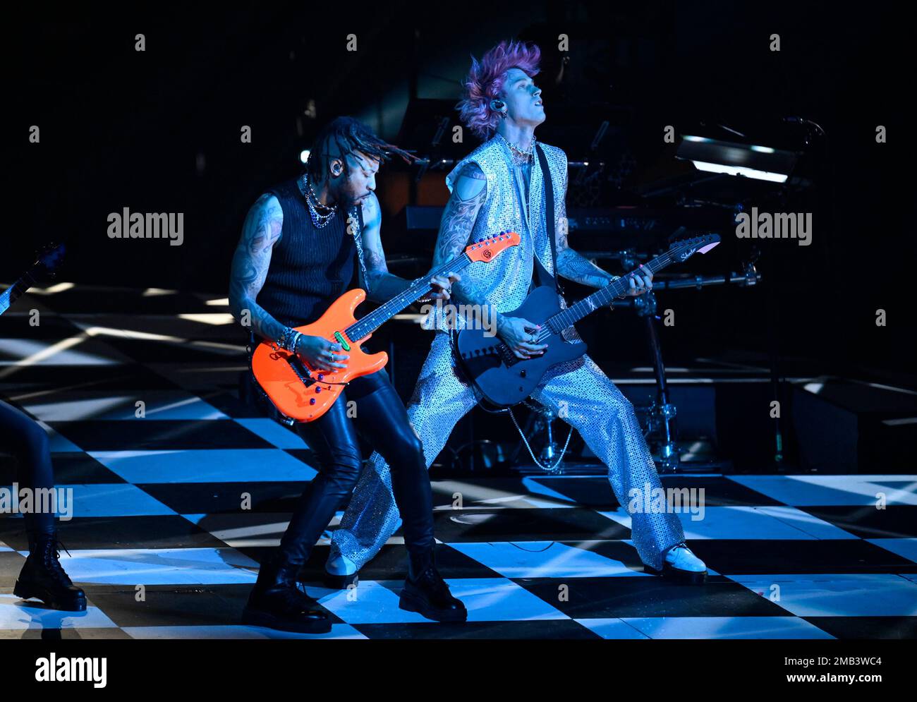 Guitarist AJ Tyus, left, performs with recording artist Machine Gun ...