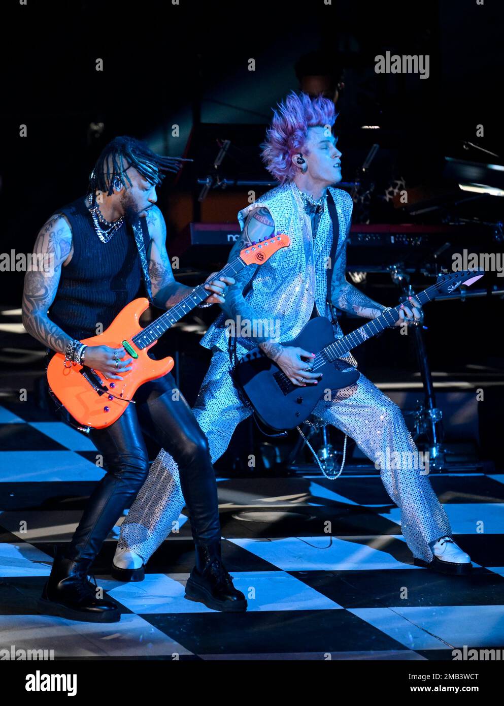 Guitarist AJ Tyus, left, performs with recording artist Machine Gun ...