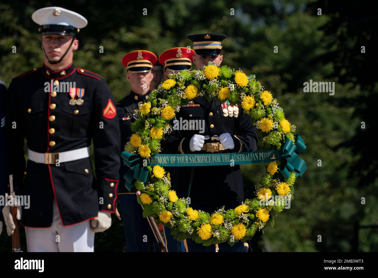 An honor guard carries the wreath during a full honor wreath-laying ...