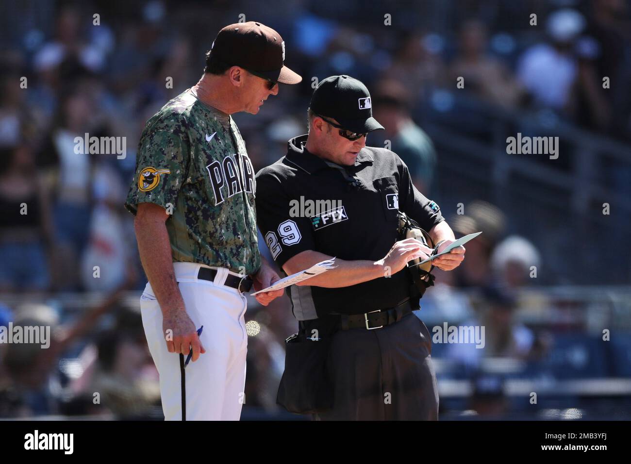 San Diego Padres manager Bob Melvin, left, makes a lineup change with ...