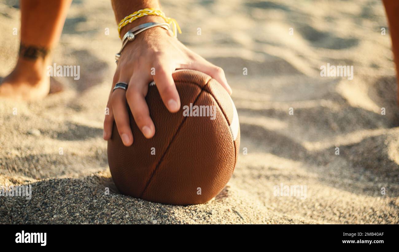Playing american football on the beach Stock Photo - Alamy