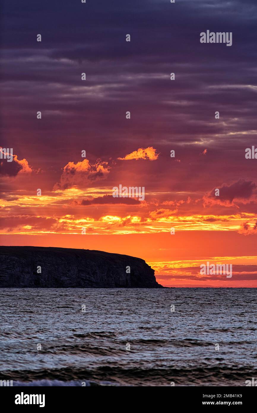 Silhouette of the island Lilla Karlsoe, sun rays behind clouds ...