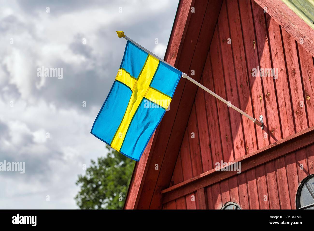 Swedish flag, national flag on a red wooden gable, Swedish house ...