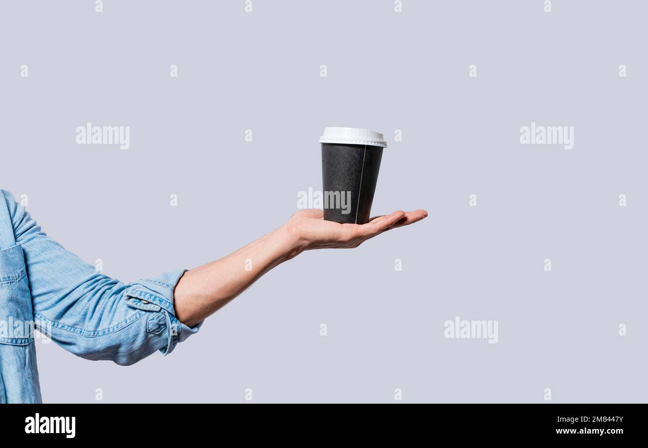 Hand holding a coffee to go on isolated background, Close up of hand ...