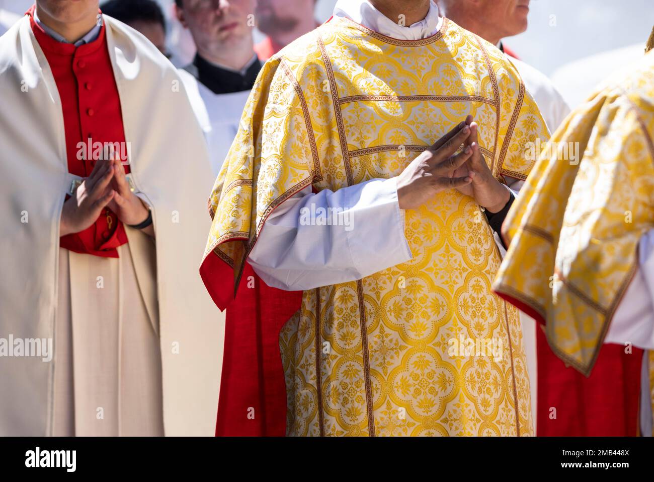 Praying altar boys with folded hands during the Corpus Christi ...