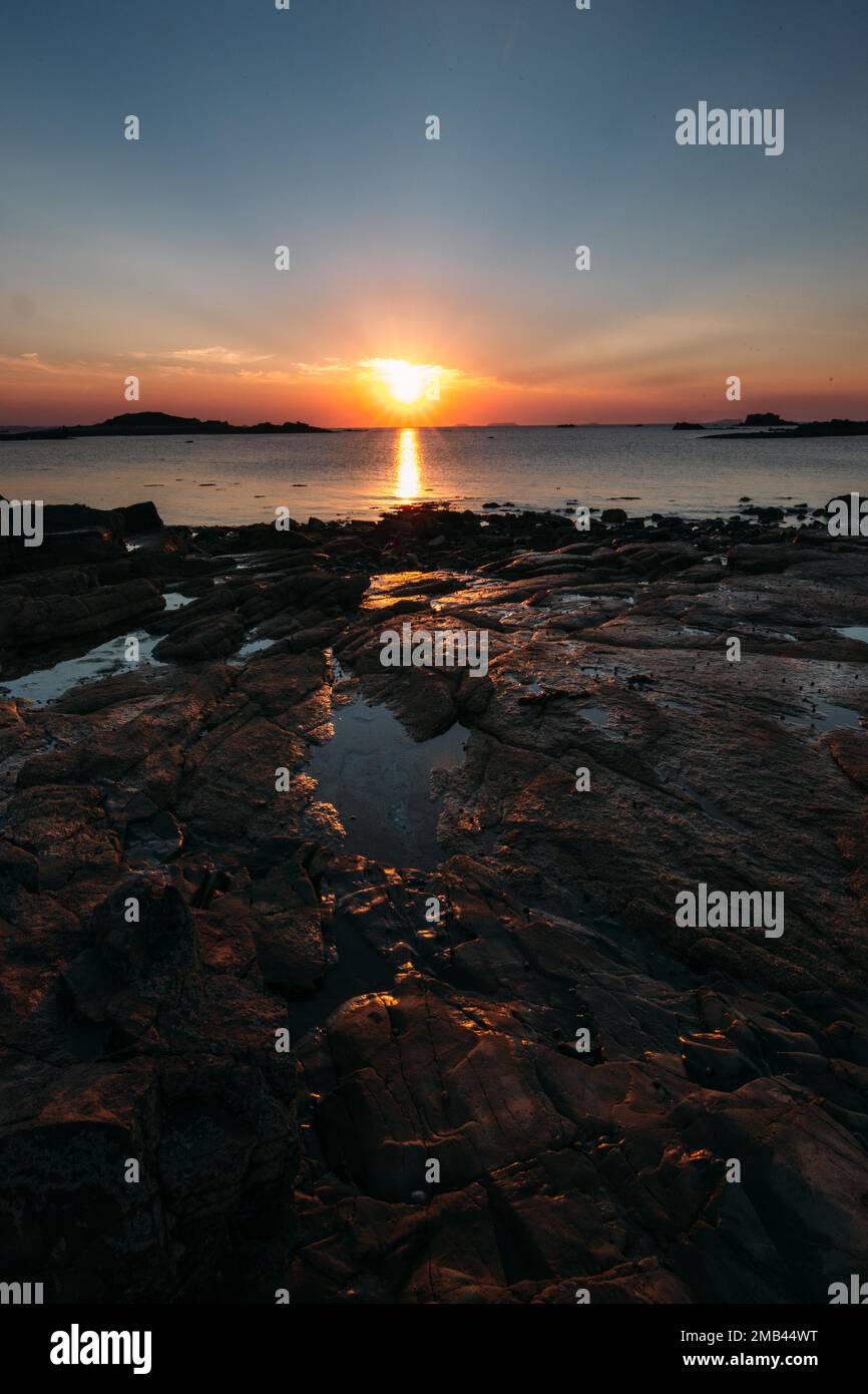 Rocks on the beach of Port Blanc in the evening light, Brittany, France ...
