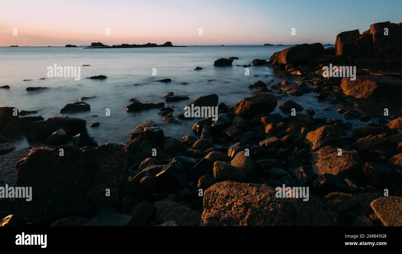 Rocks on the beach of Port Blanc in the morning light, Brittany, France ...