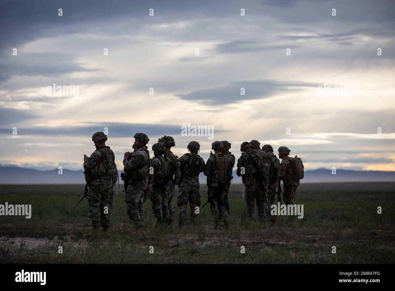 Soldiers from Bravo Battery, 1st Battalion, 145th Field Artillery, Utah National Guard, watch as ...