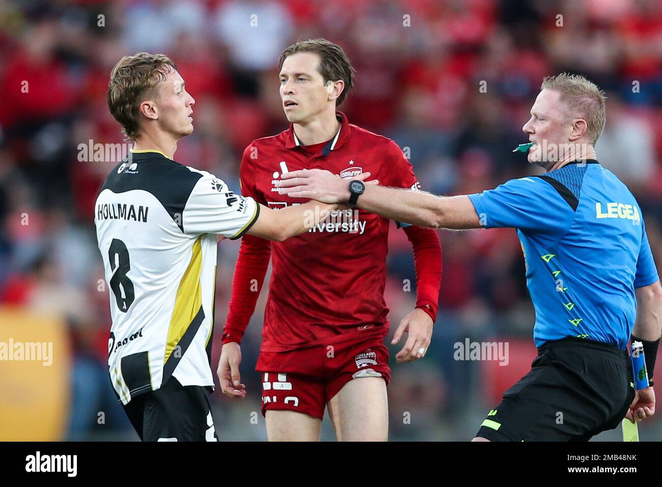 Craig Goodwin of Adelaide United and Jake Hollman of the Bulls clash as ...