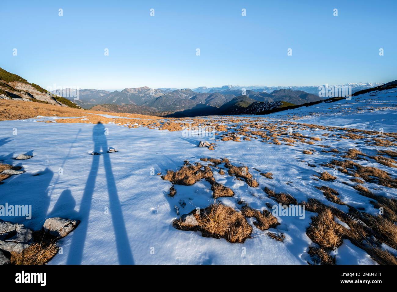 Shadow of a climber, plateau with first snow, hiking trail at ...