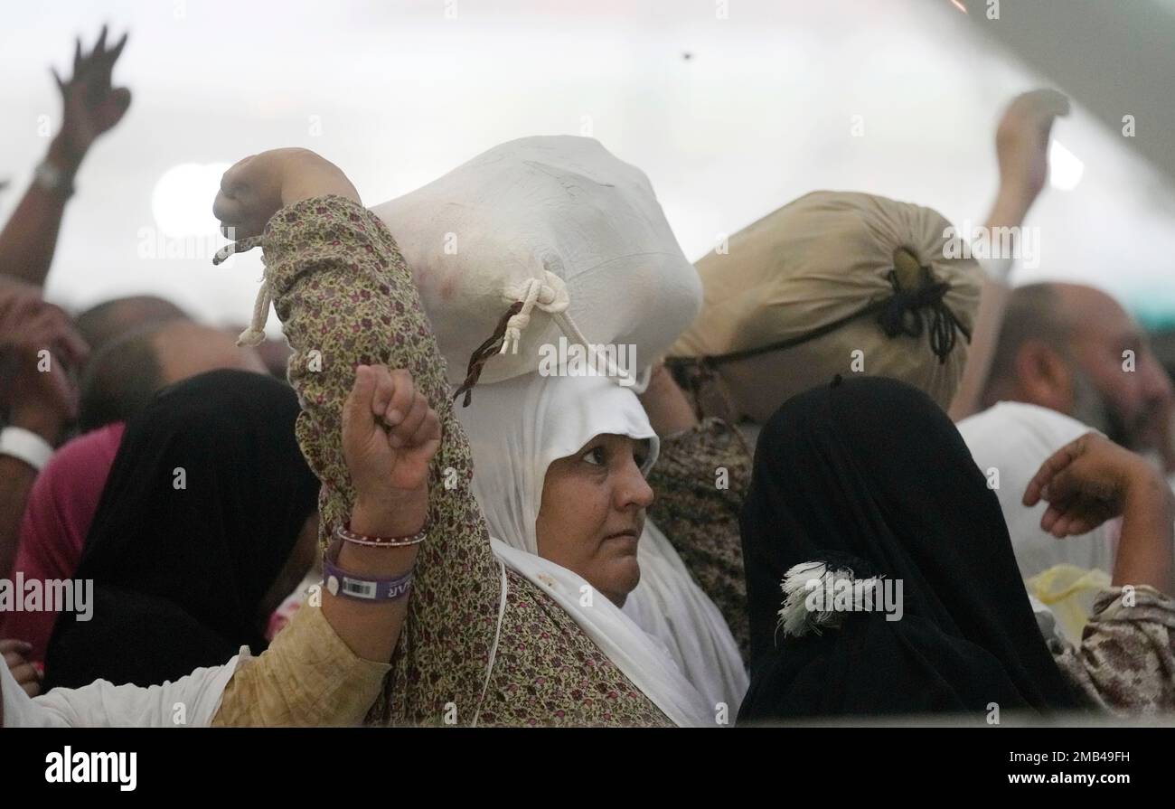 A Muslim pilgrim casts stone in the symbolic stoning of the devil ...