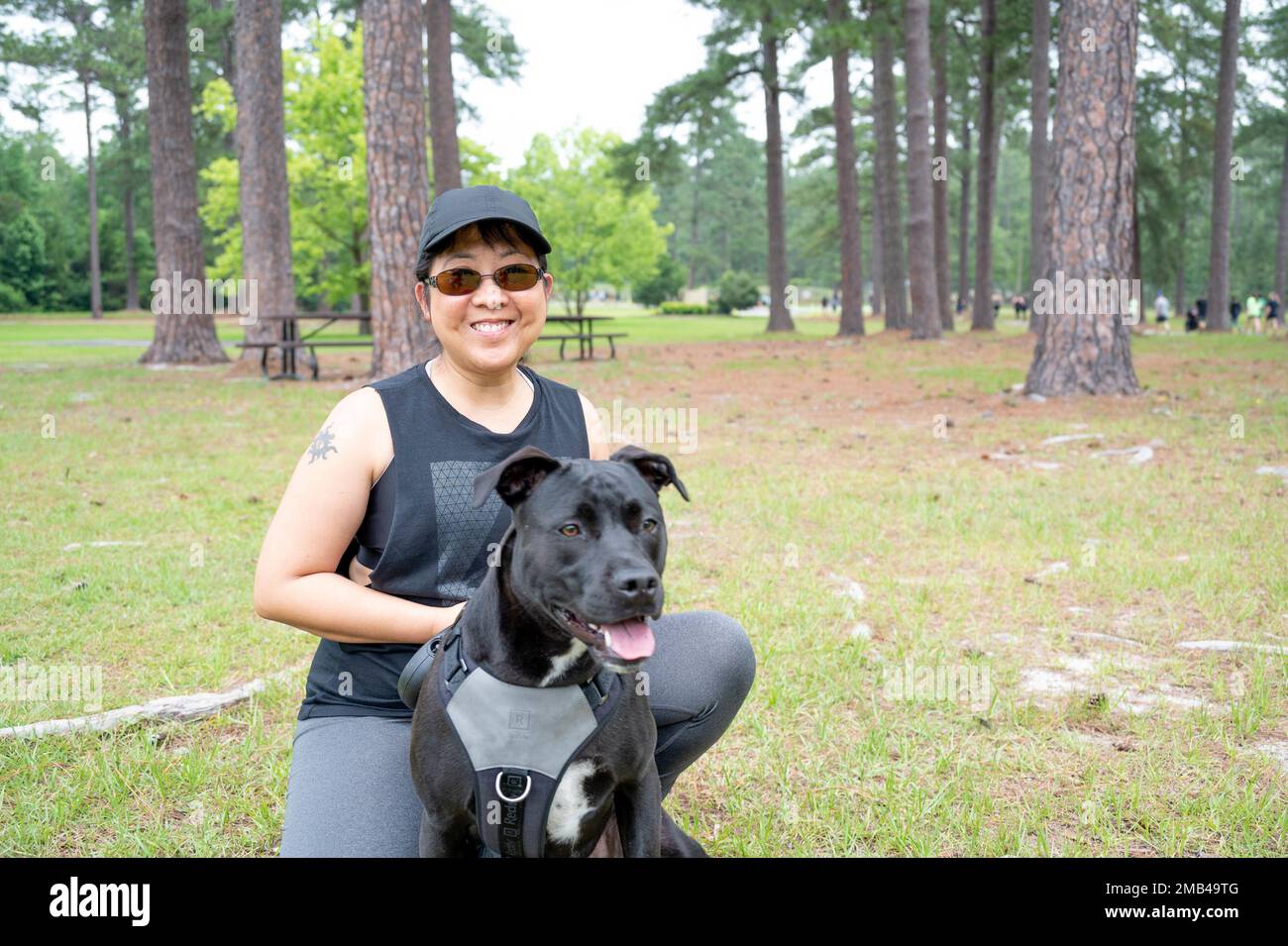 Victoria Fonseca and her pup Puddles watch and cheer for the runners ...