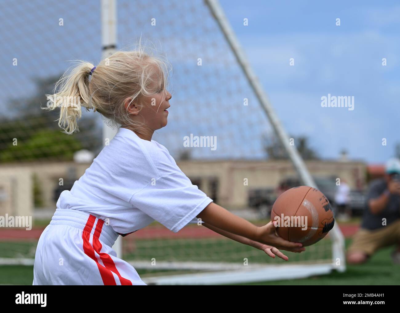 A child catches a football during a Football ProCamp on Andersen Air ...