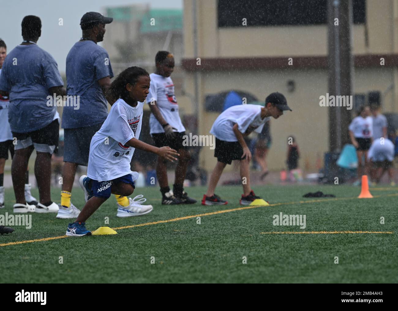 Children run drills in the rain during a Football ProCamp on Andersen ...