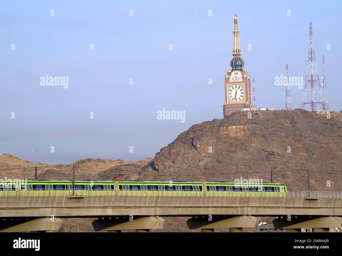 A Mecca Metro train passes the world tallest clock tower during the ...