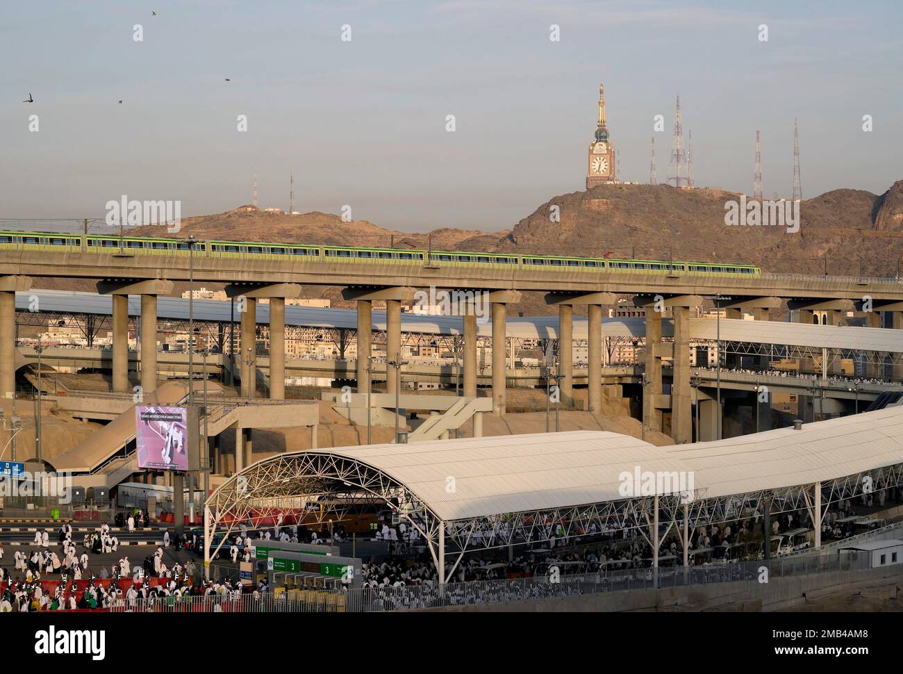 A Mecca Metro train passes the world tallest clock tower during the ...